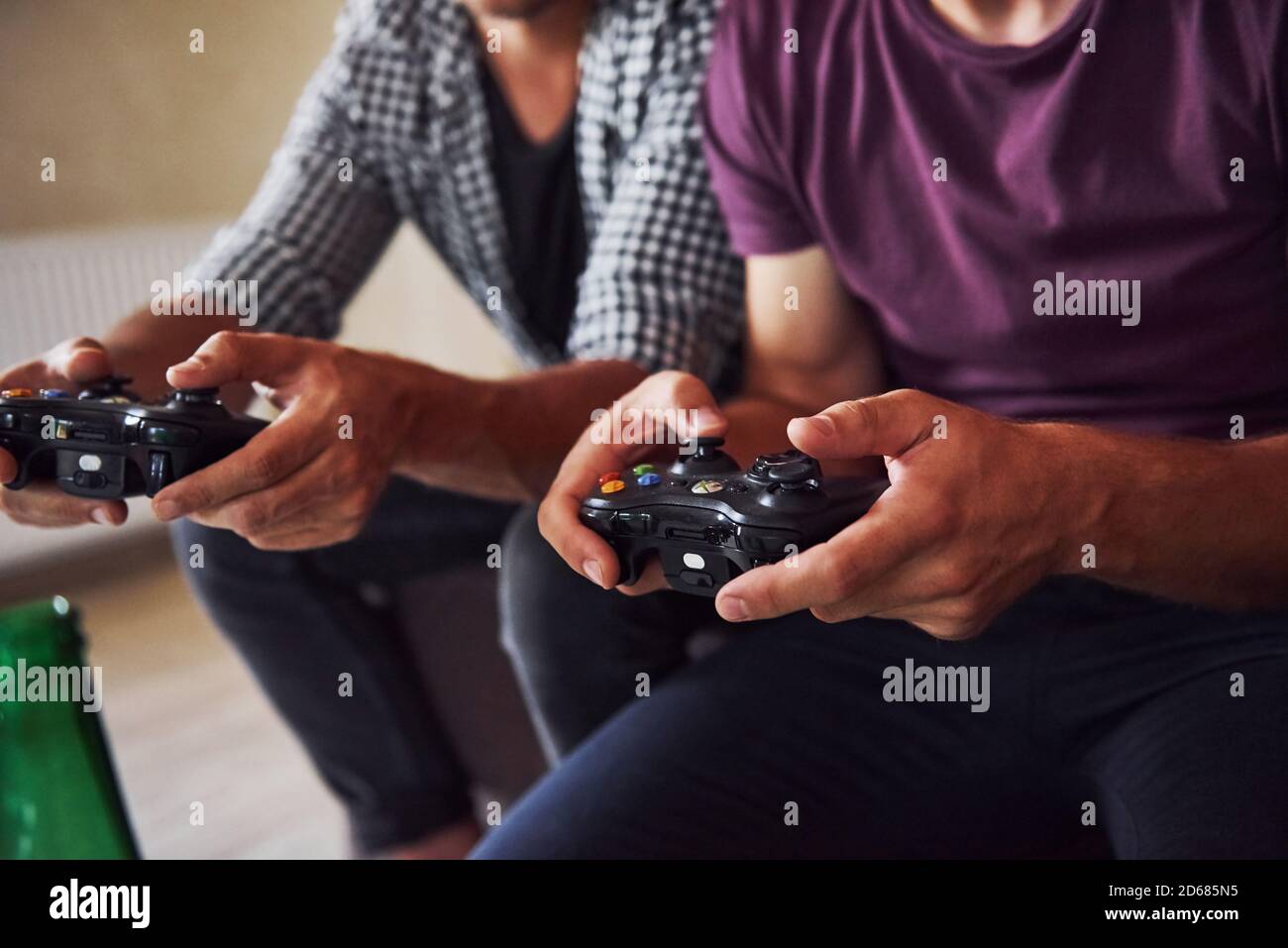 Group of friends have fun playing console game indoors at living room ...