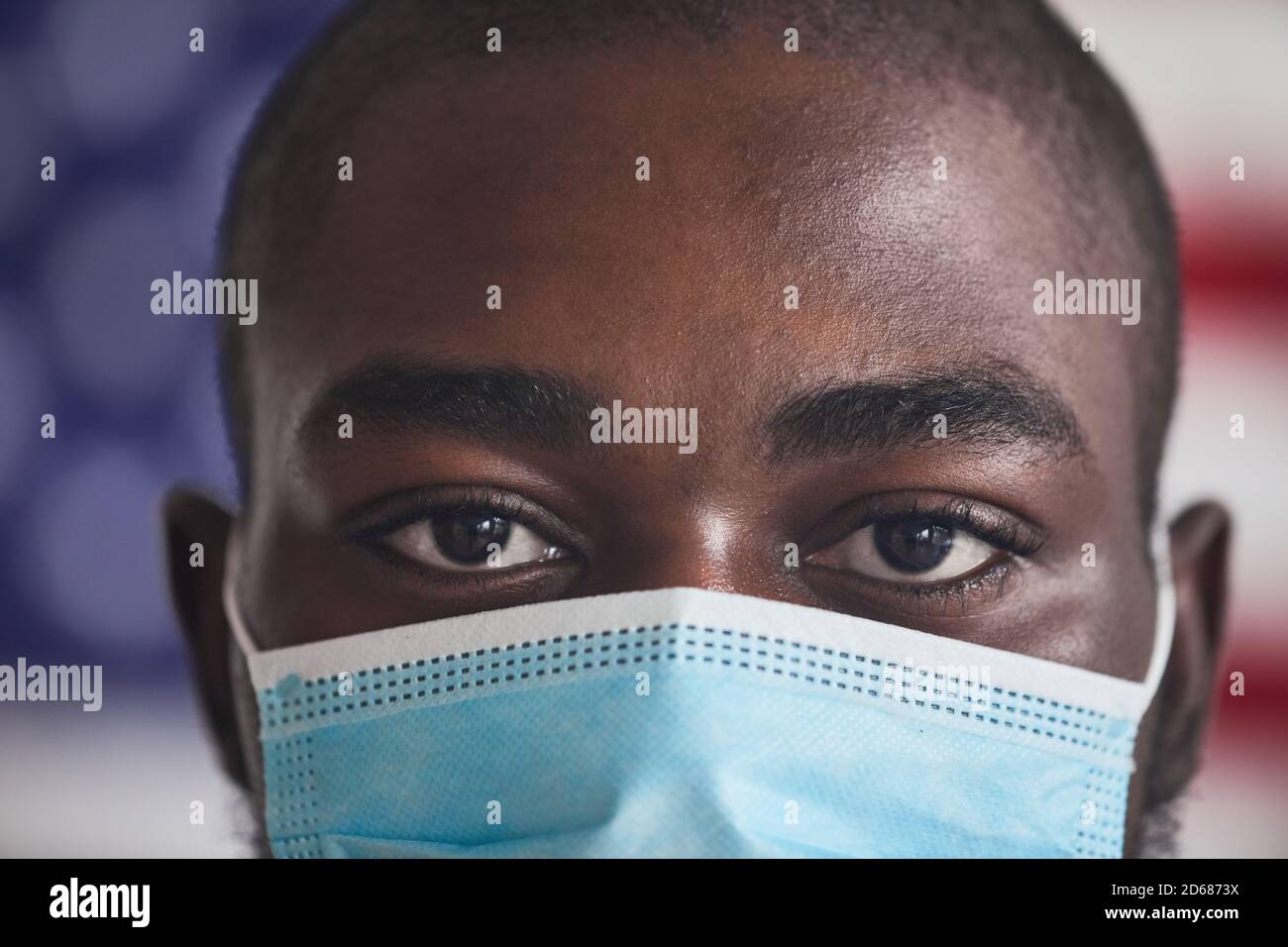 Close-up of African young man wearing protective mask during pandemic ...