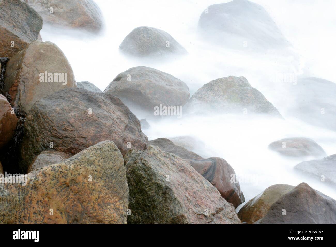stones in the water in denmark shot with slow shutter speed Stock Photo ...