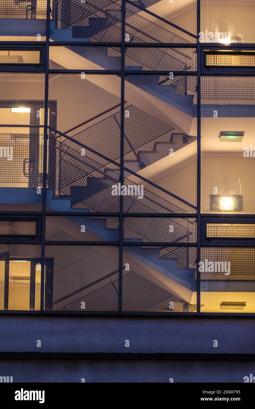 empty stairwell with staircase illuminated inside modern housing block ...