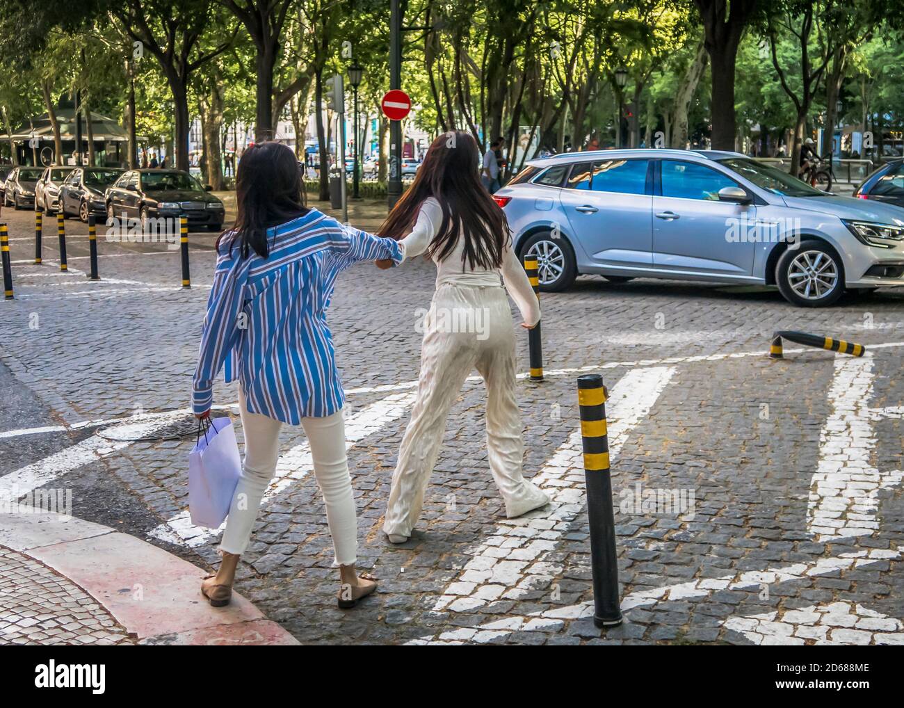 A girl holding her friend back from doing the wrong thing. When you ...