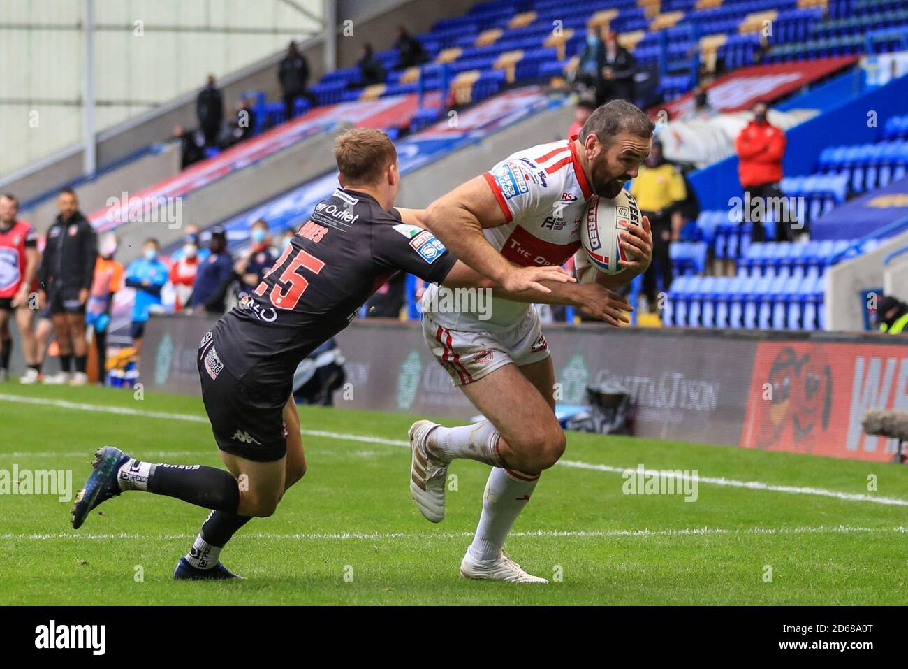 Kane Linnett (4) of Hull KR is stopped from crossing the line by Connor ...