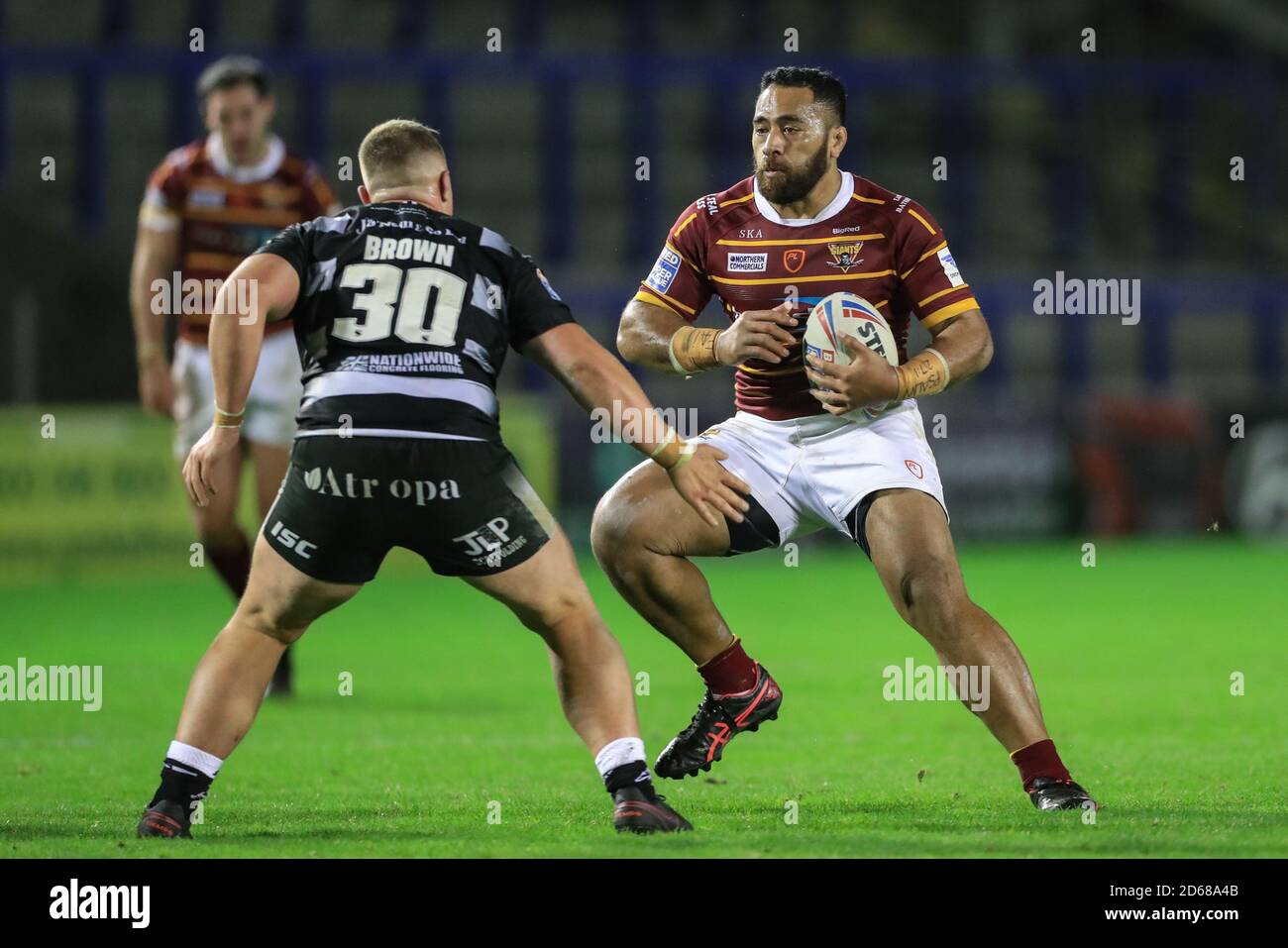 Suaia Matagi (10) of Huddersfield Giants heads in to the tackle of Jack ...