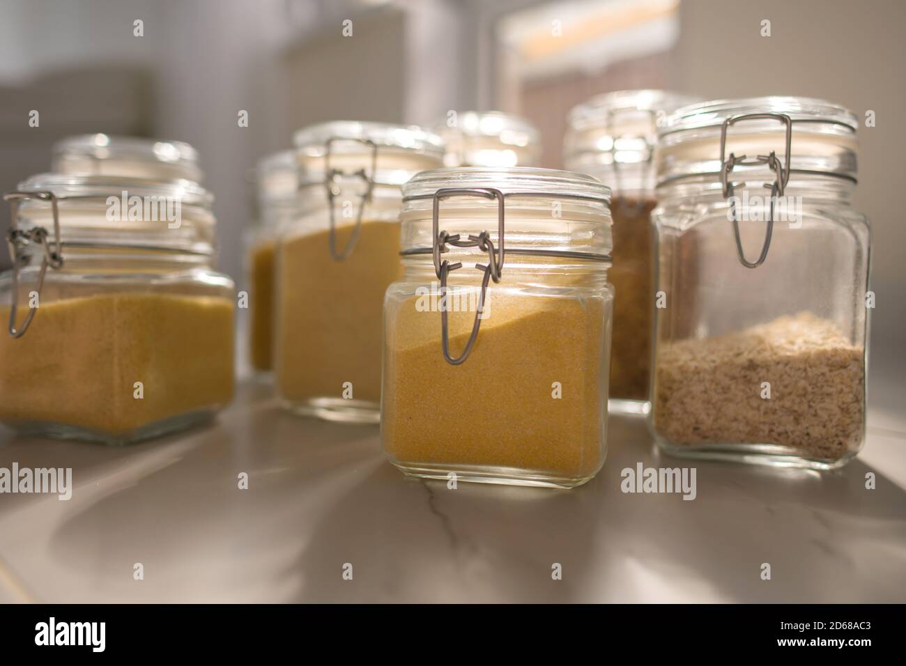 Collection of grain productsin storage jars over on kitchen. Jar of ...