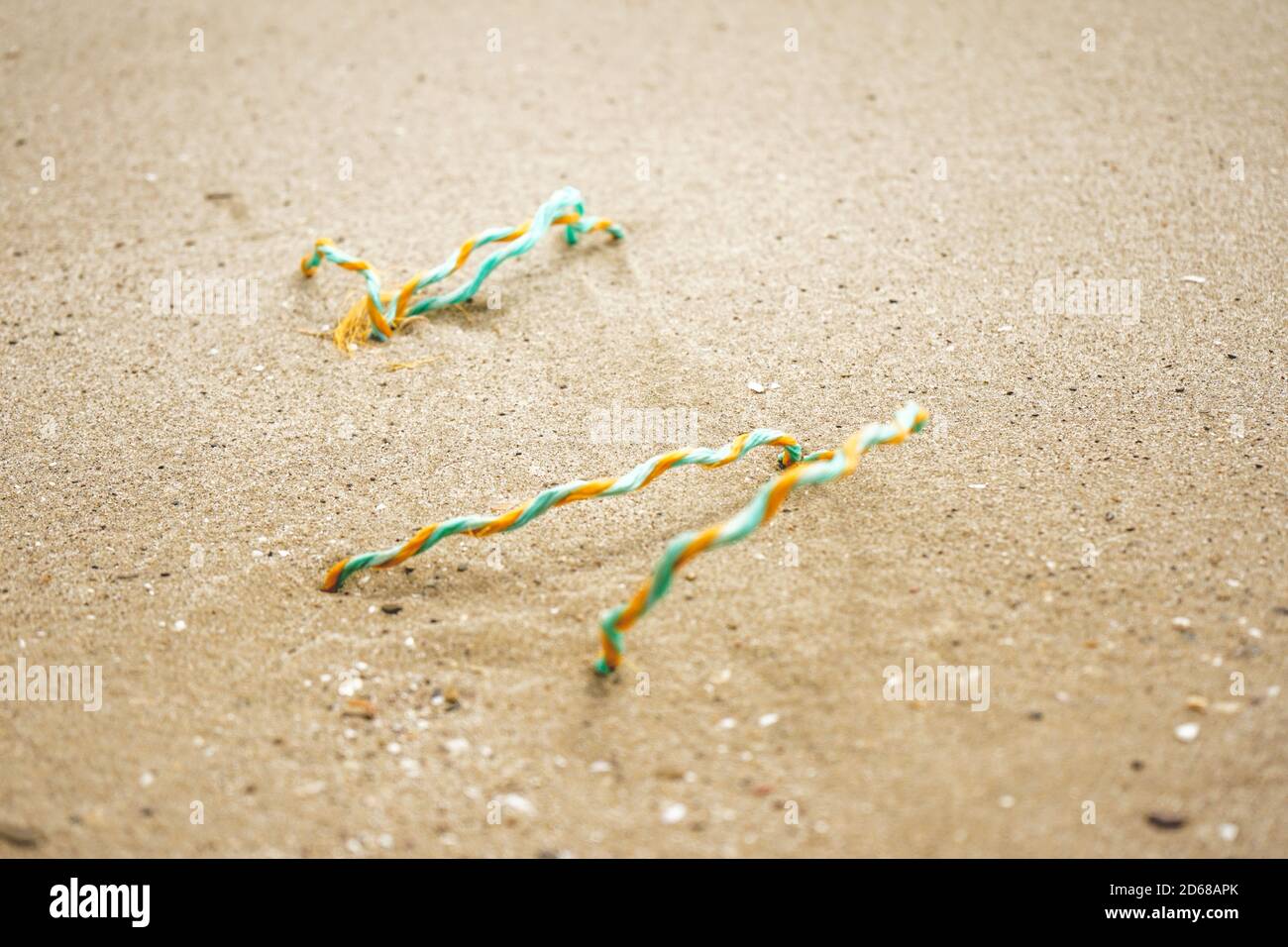 Plastic and microplastic in the sand beach Stock Photo - Alamy