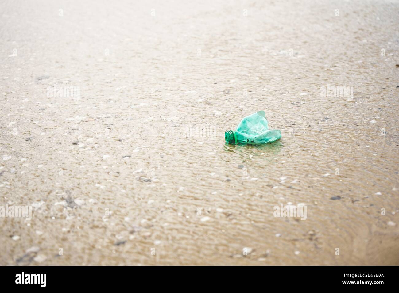Plastic and microplastic in the sand beach Stock Photo - Alamy