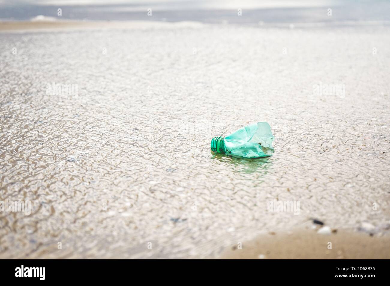 Plastic and microplastic in the sand beach Stock Photo - Alamy