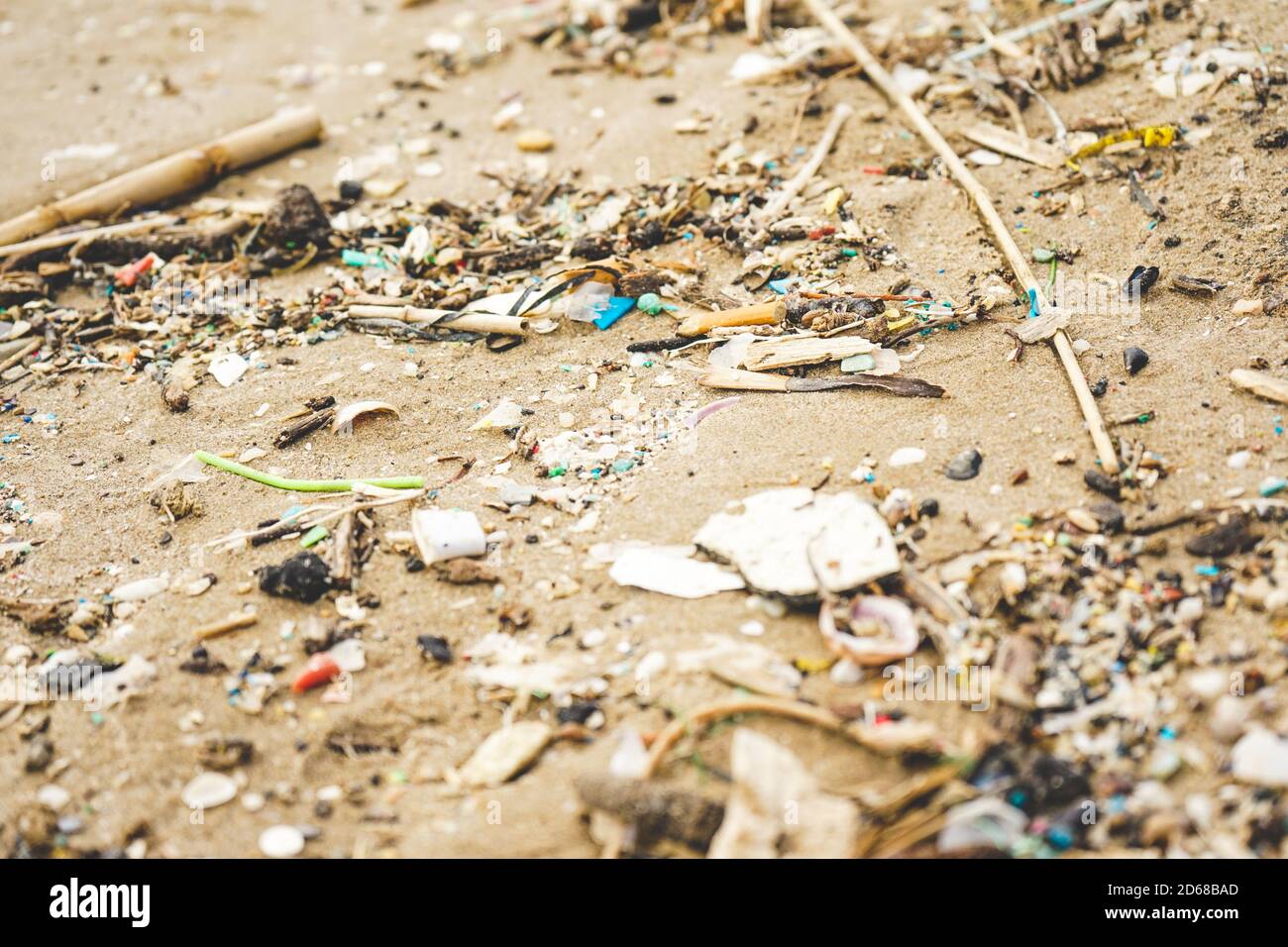 Plastic and microplastic in the sand beach Stock Photo - Alamy