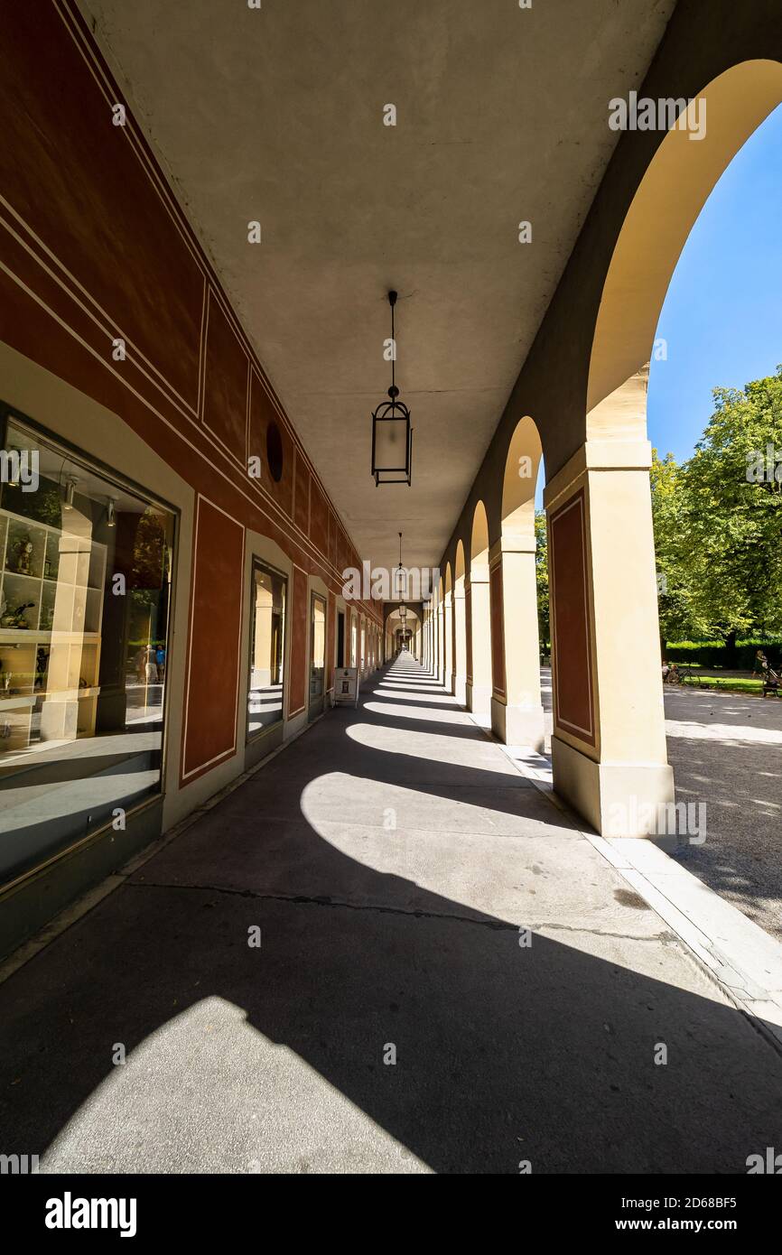 Promenade with long arcade columns surrounding Hofgarten Park in Munich ...