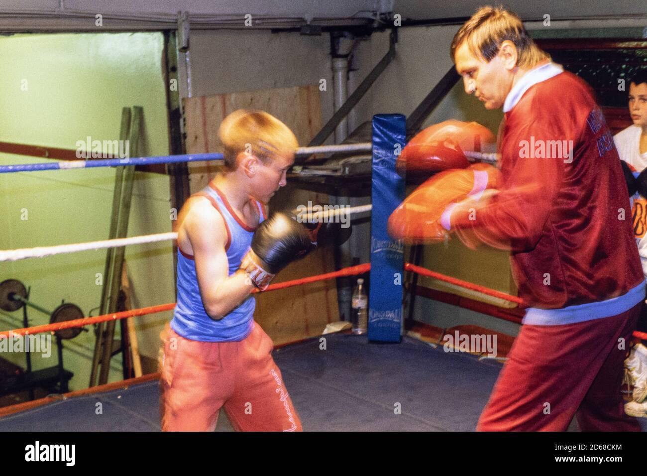 Coach Jimmy Green working the pads with one of the young boxers that he ...