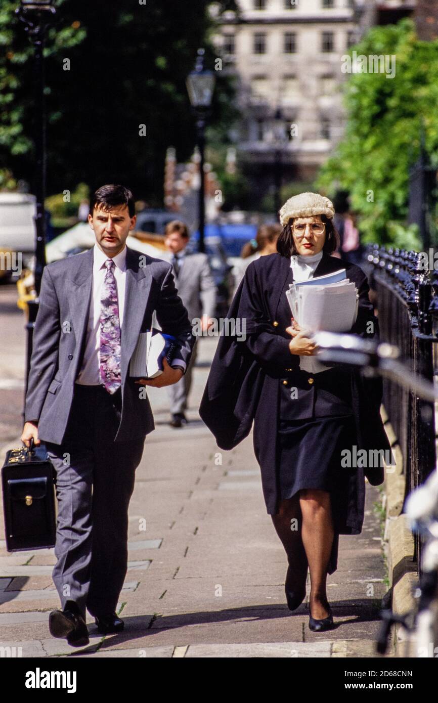 A Barrister and her colleague walk through Lincoln’s Inn towards the ...