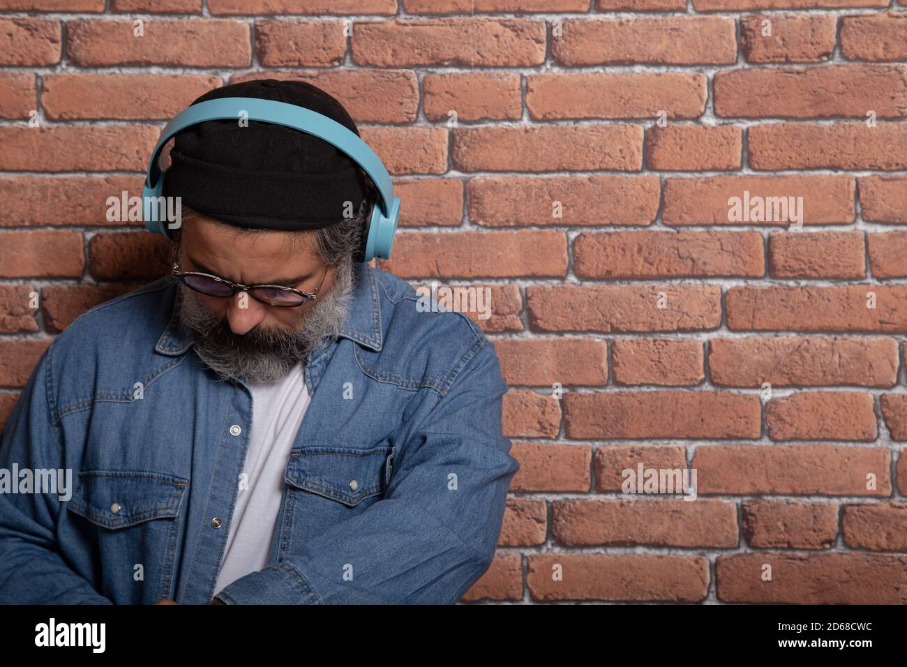 Caucasian male listening to music by headphones Stock Photo - Alamy
