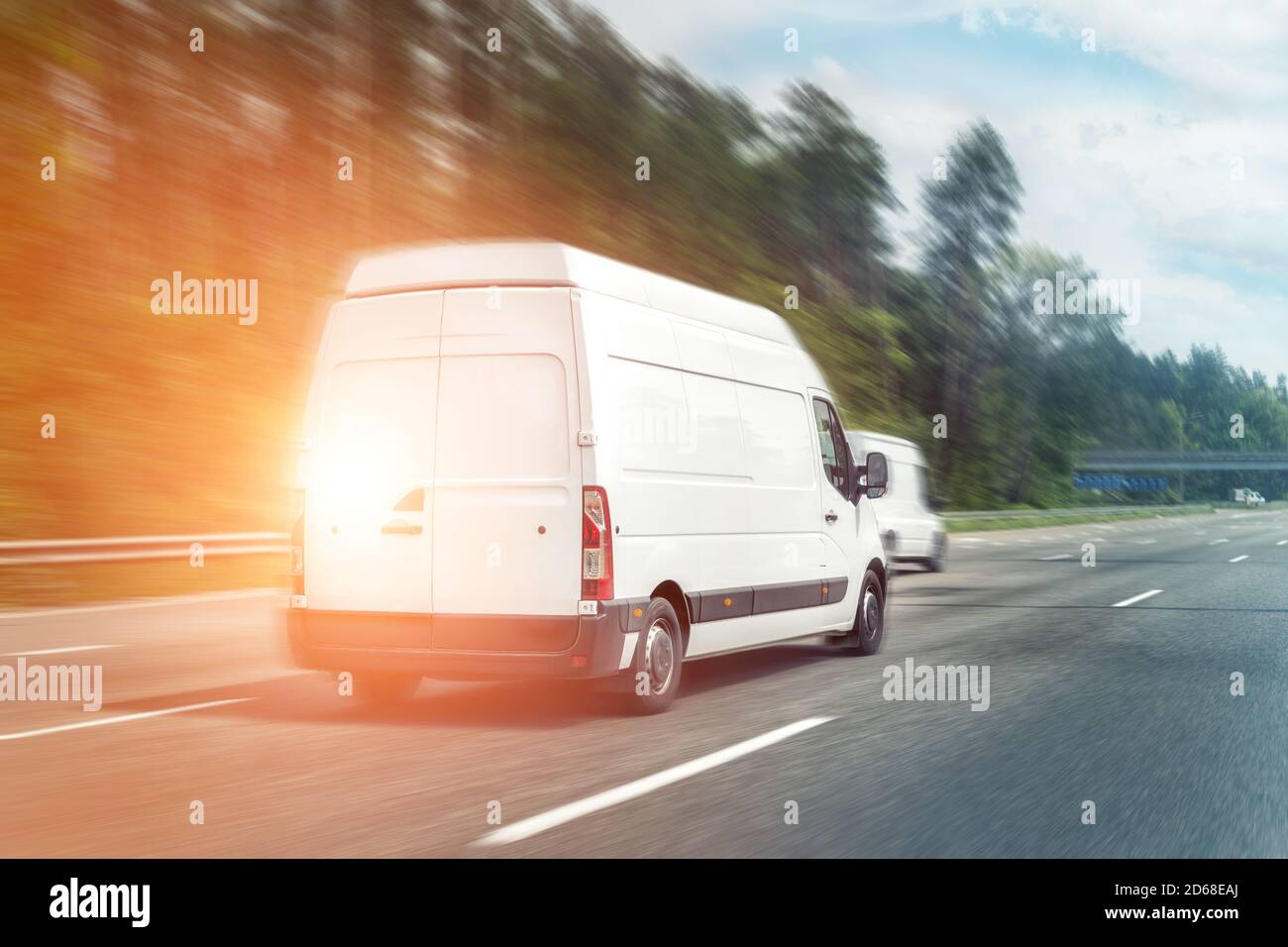 White modern delivery small shipment cargo courier van moving fast on ...