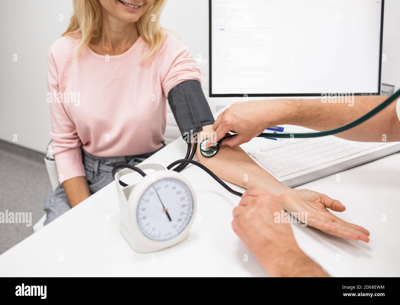 Doctor measuring arterial blood pressure of a patient, close-up Stock ...