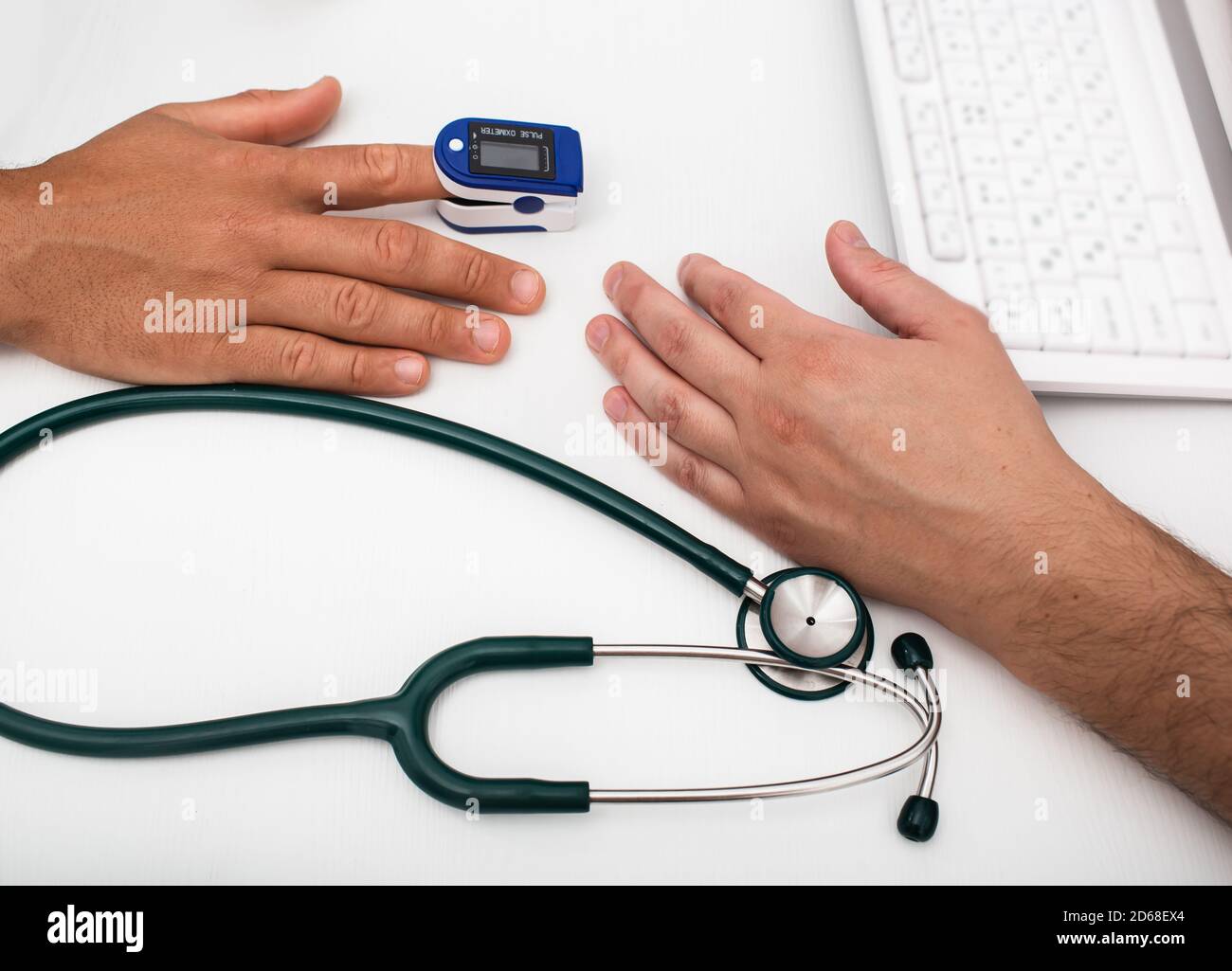 Pulse oximeter measure pulse rate and oxygen, on male finger close-up ...