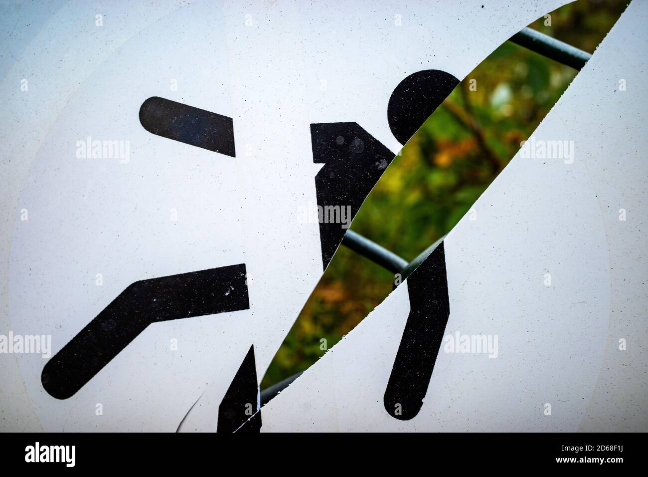 Damaged on entry sign on a security fence Stock Photo - Alamy