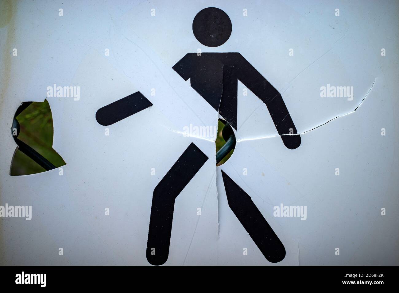 Damaged on entry sign on a security fence Stock Photo - Alamy