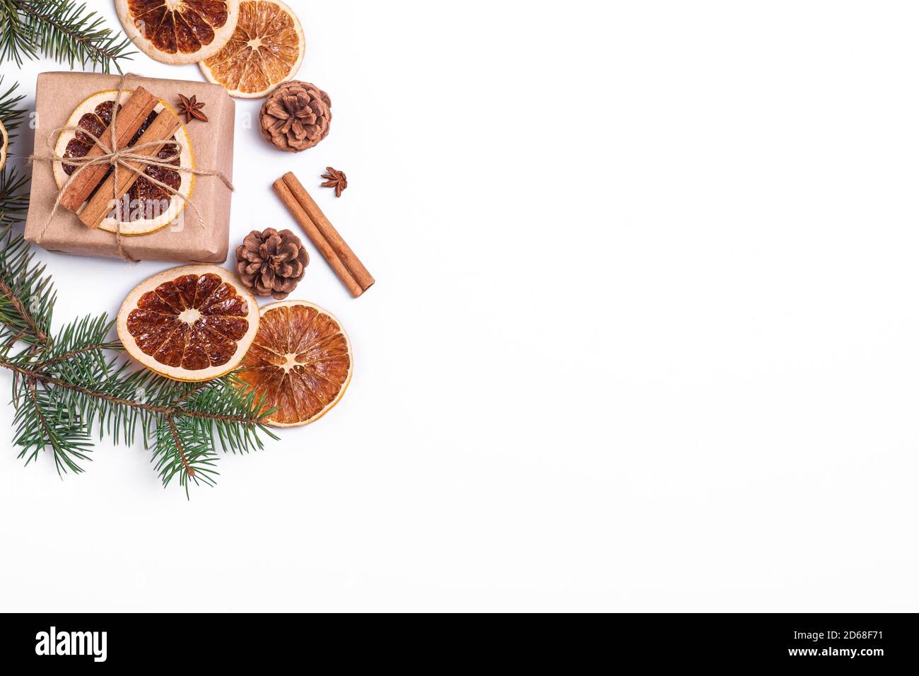 Christmas composition with handmade kraft paper gift box, dried citrus ...