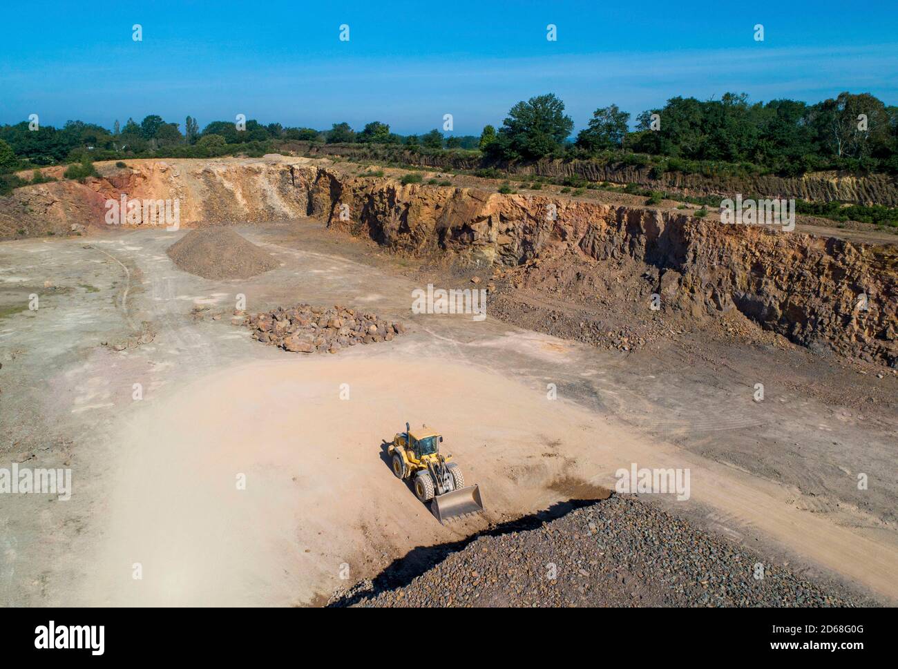 Aerial view of a digger in a quarry in front of a pile of rubble Stock ...