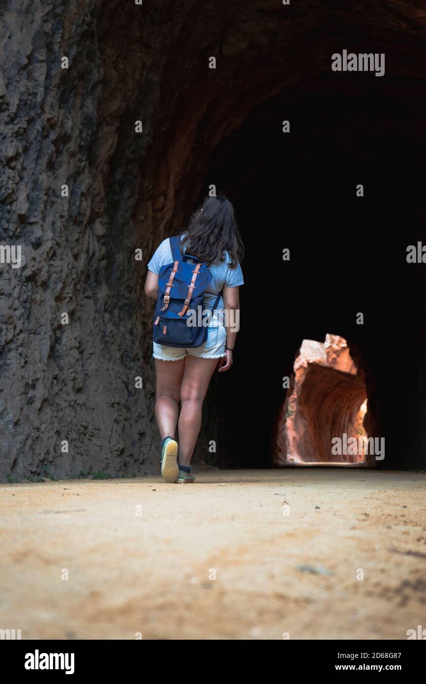 Woman walking in a cavern Stock Photo - Alamy