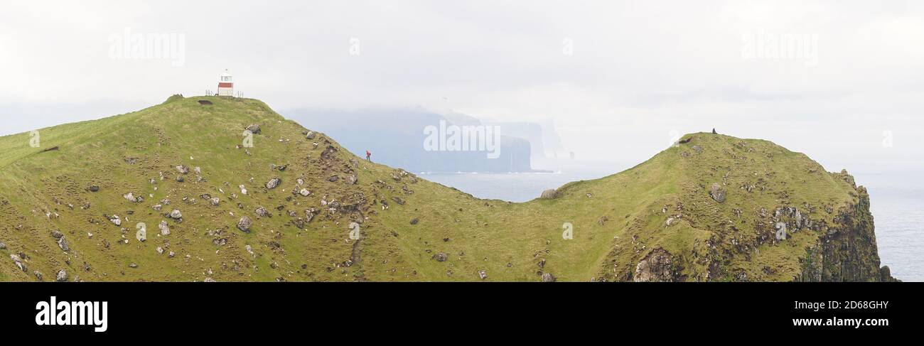 Kallur Lighthouse on Kalsoy Island with green lush cliff landscapes and ...