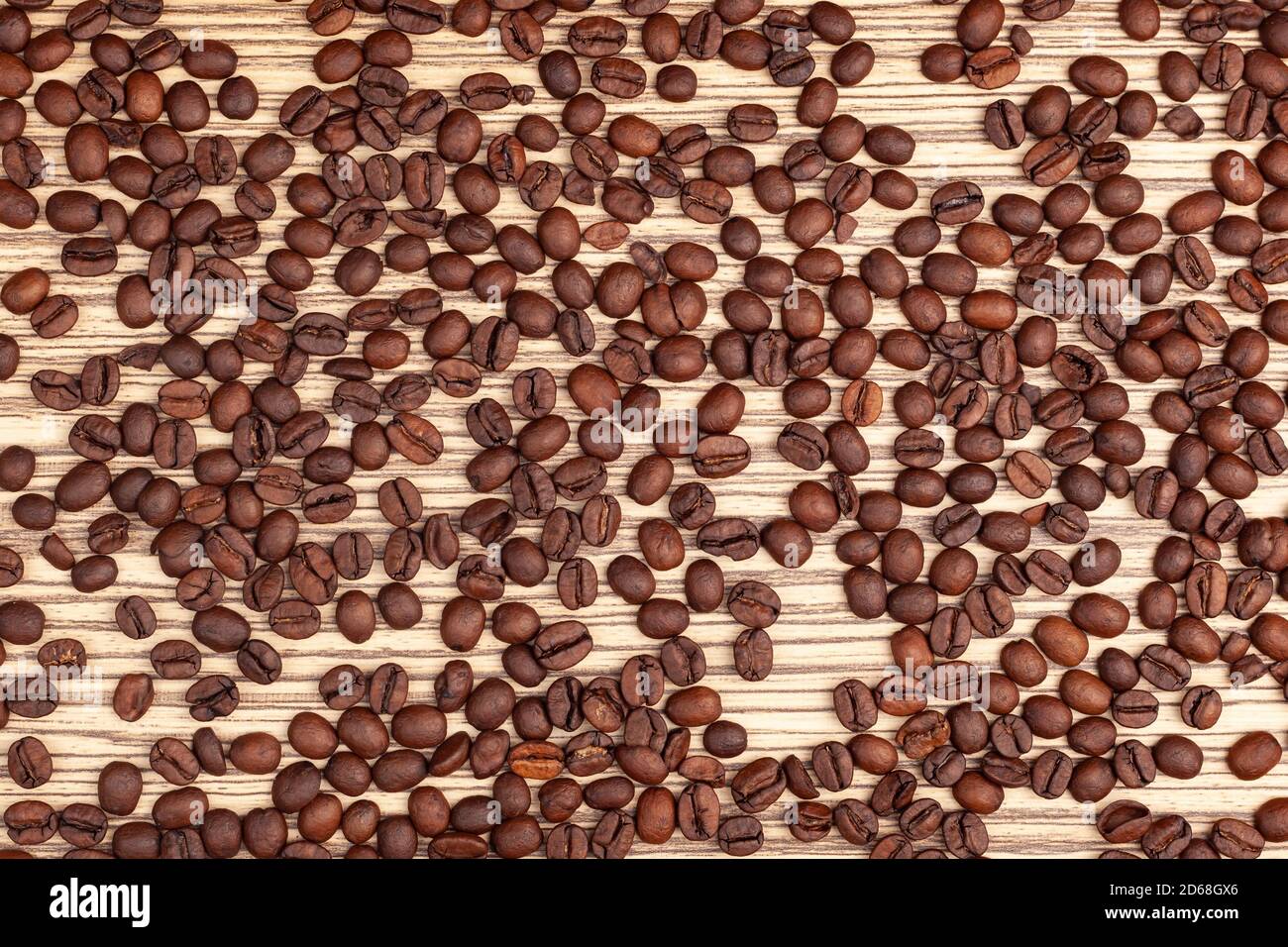 coffee beans on a light brown striped background Stock Photo - Alamy