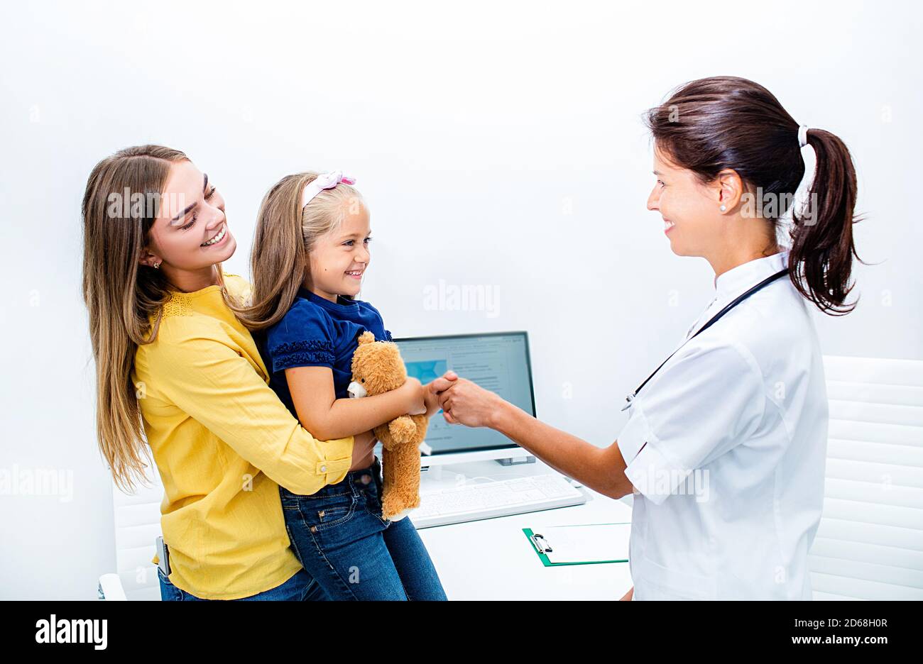Cute child patient have handshaking a friendly doctor after a medical ...