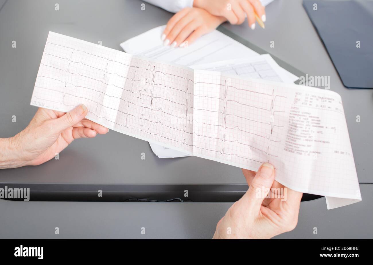 Senior patient looking at the results of a cardiogram of heart in a ...