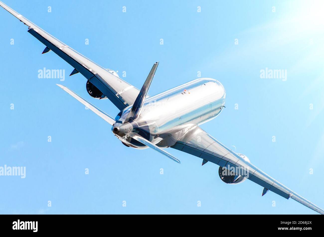 Passenger airplane shiny fuselage and climbing flight Stock Photo - Alamy