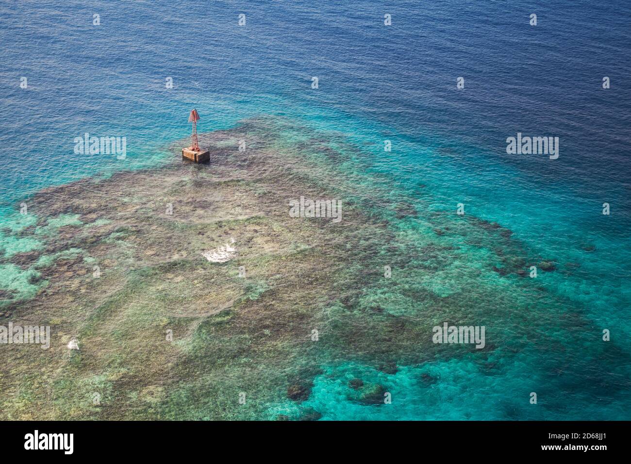Red beacon, framed tower with triangle top mark stands in water of ...