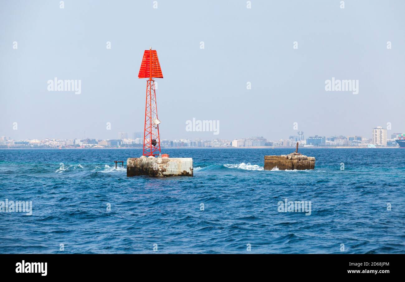Red beacon framed tower with triangle top mark stands near wreck in ...