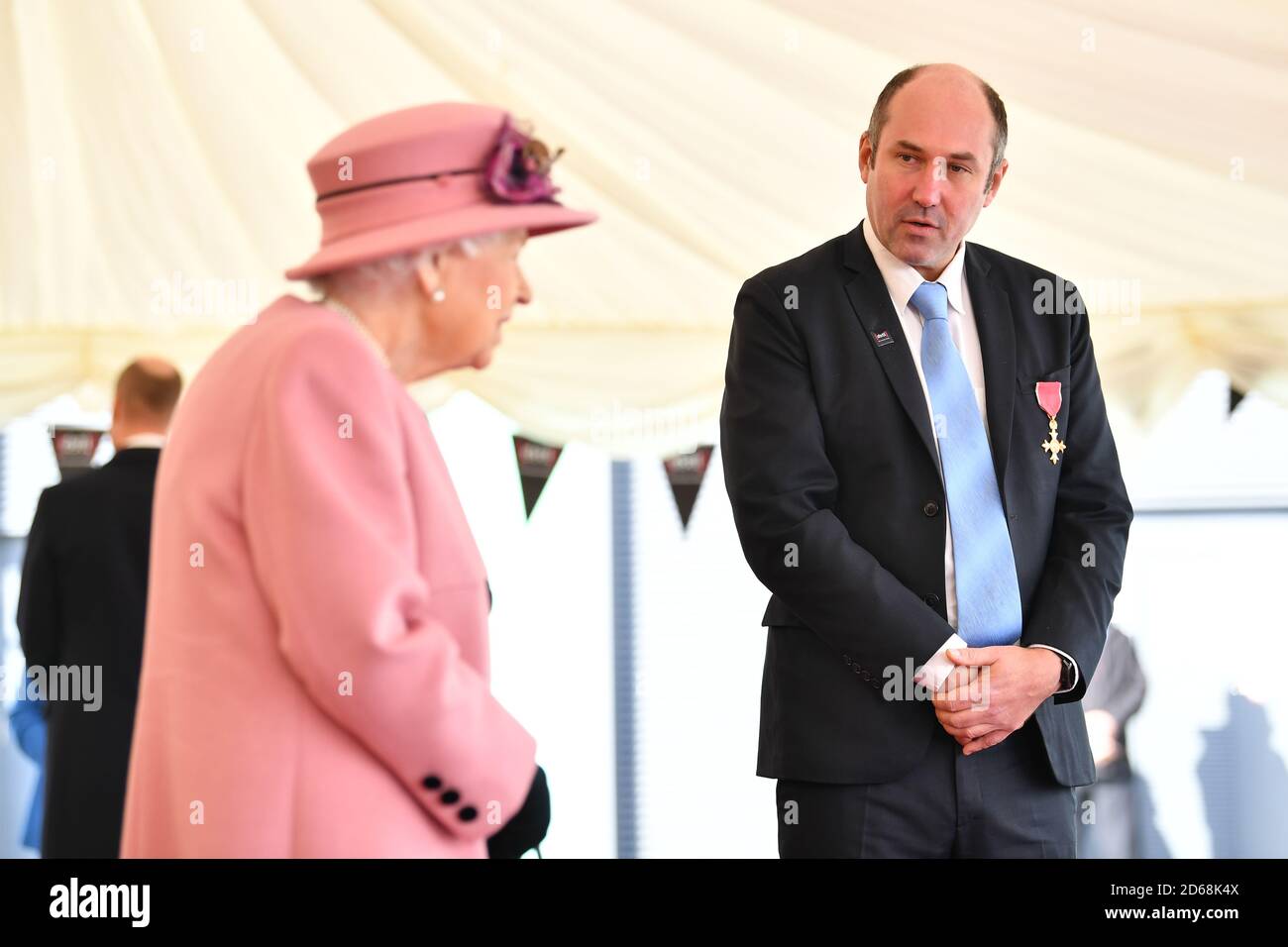 Queen Elizabeth II speaks with Professor Tim Atkins, who was honoured ...