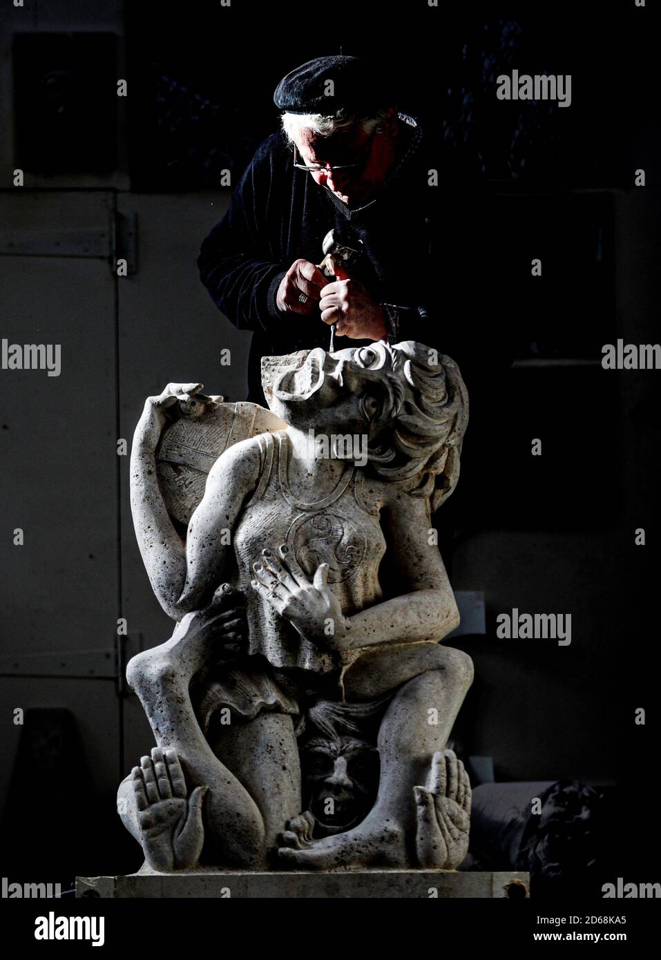 Master mason Pascal Mychalysin works on a gargoyle holding a cheese, to ...