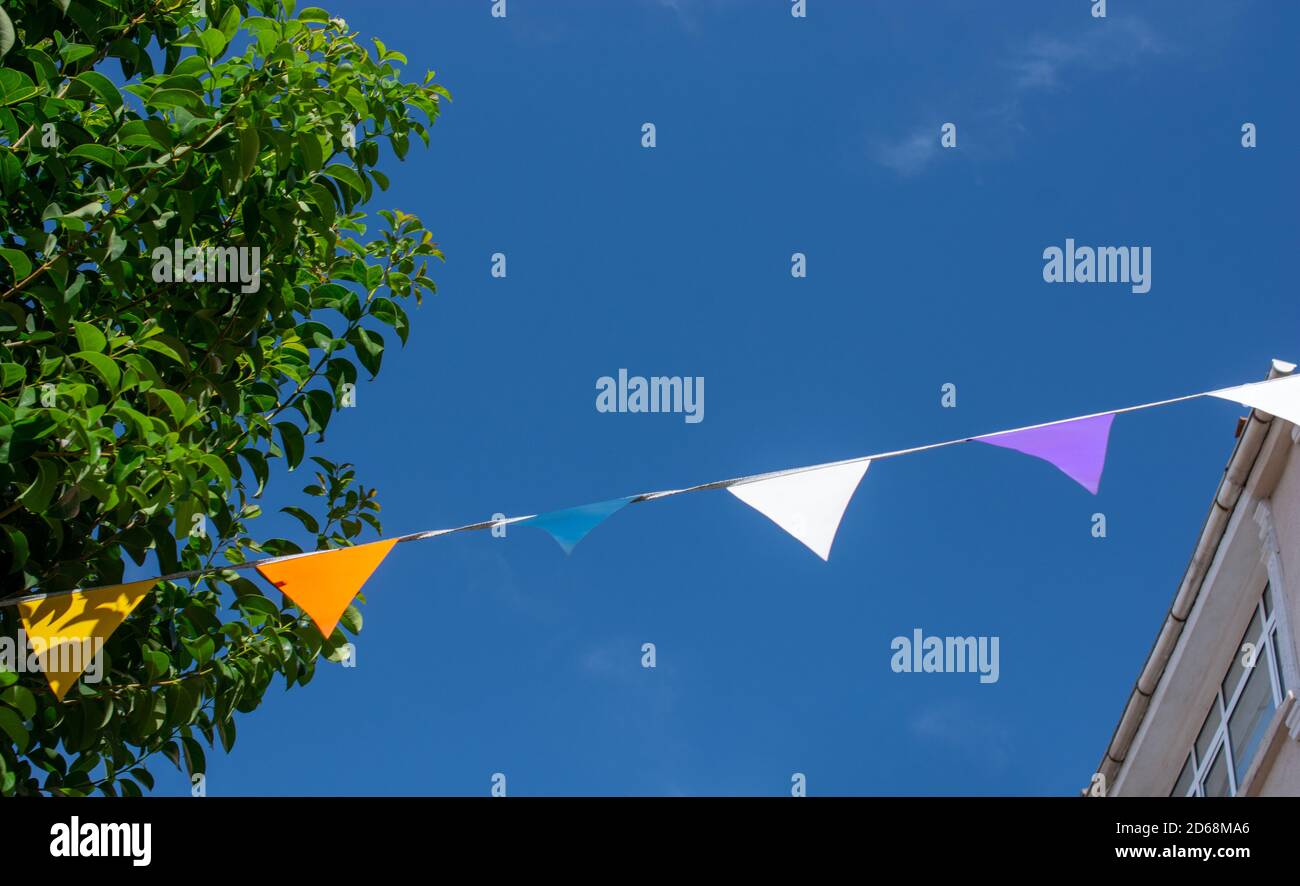 Colorful triangle bunting flags of various colors as festival concep ...
