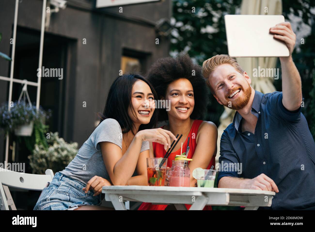 Young friends having a great time together. Group of people talking and ...