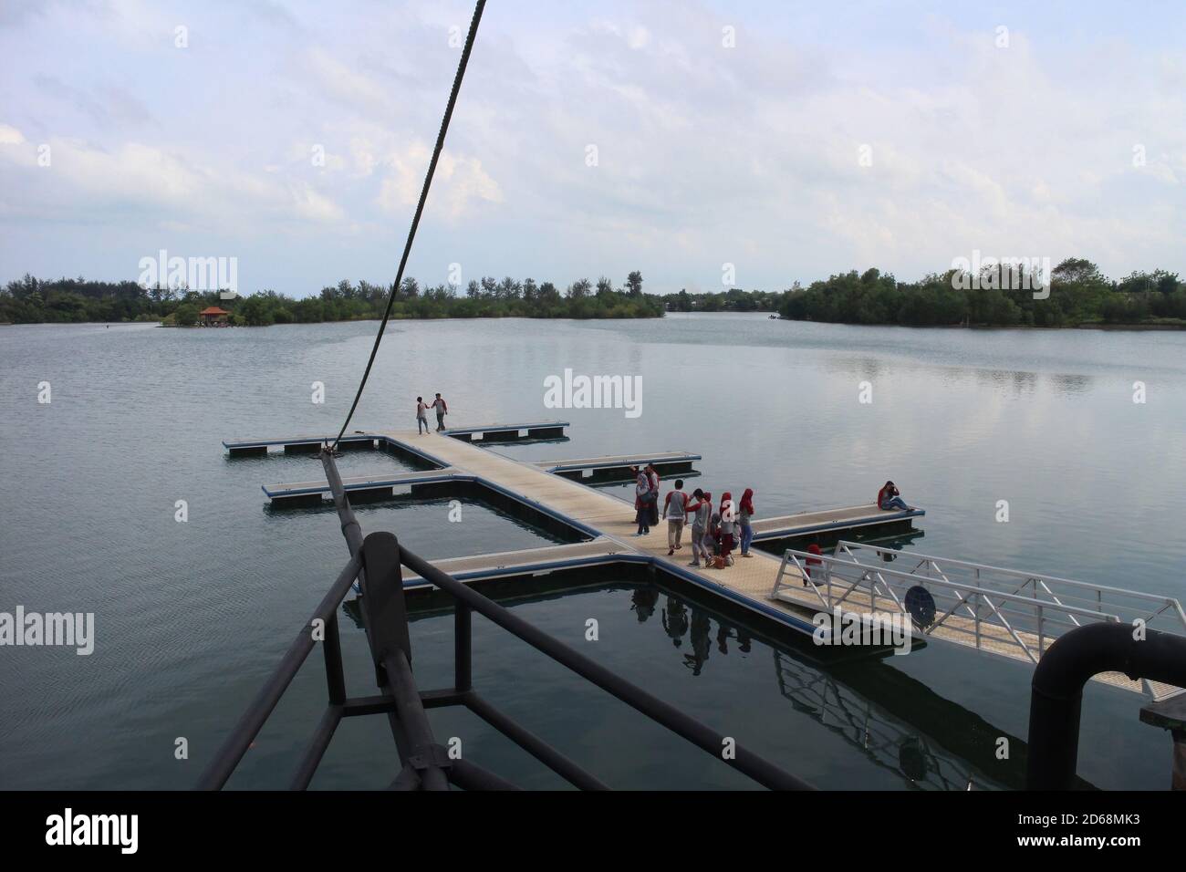 Scene of pier on the edge of a lake Stock Photo - Alamy