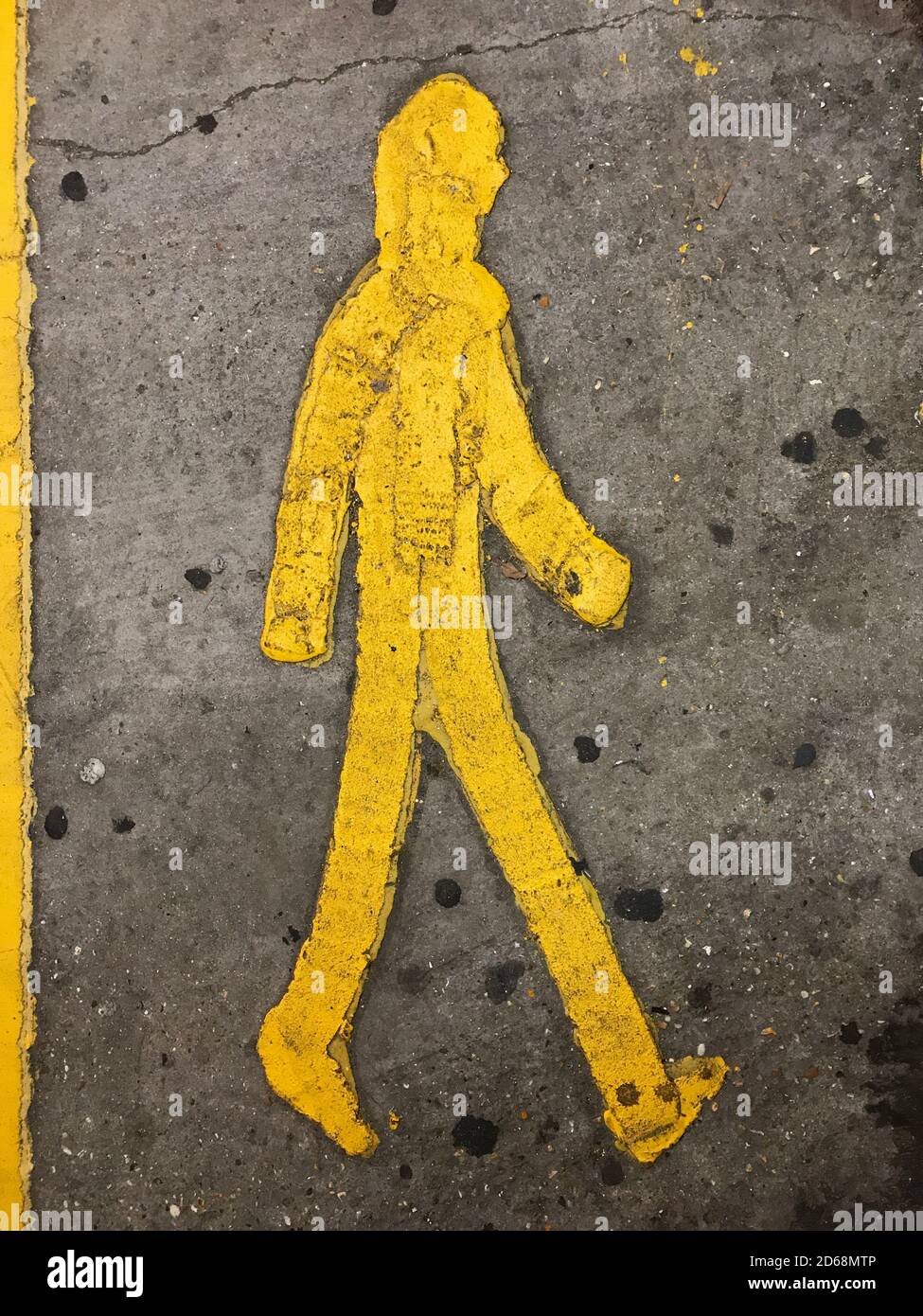 a Sign of a yellow person walking on the floor in a parkinglot Stock ...