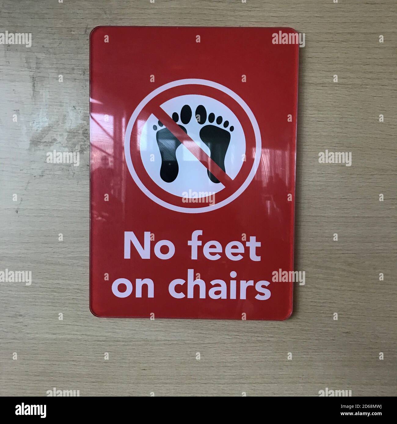 a Sign forbidden to out your feet on the chairs in English Stock Photo ...