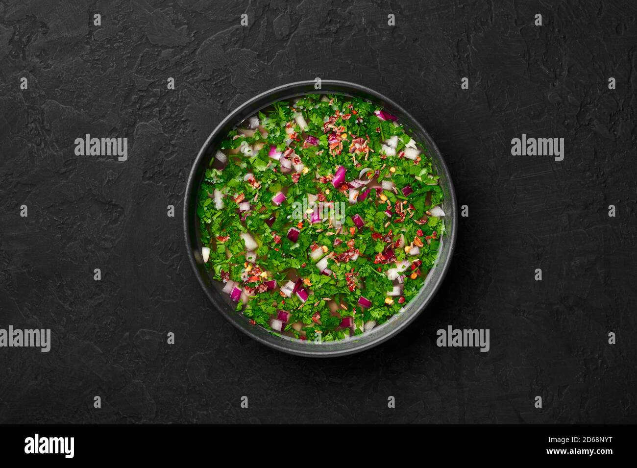 Pachi Pulusu in black bowl on dark slate table top. Raw Tamarind Rasam ...