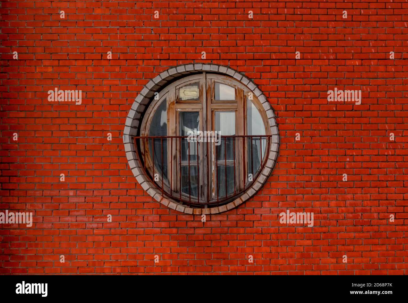 Vintage circle wooden window on a brick wall building. Architectural ...