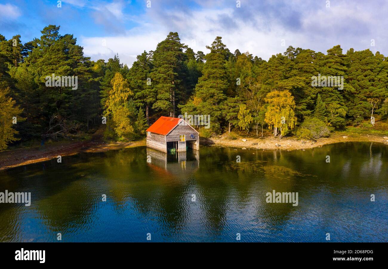 Aerial view of Loch Vaa and red boathouse in Cairngorms National Park ...
