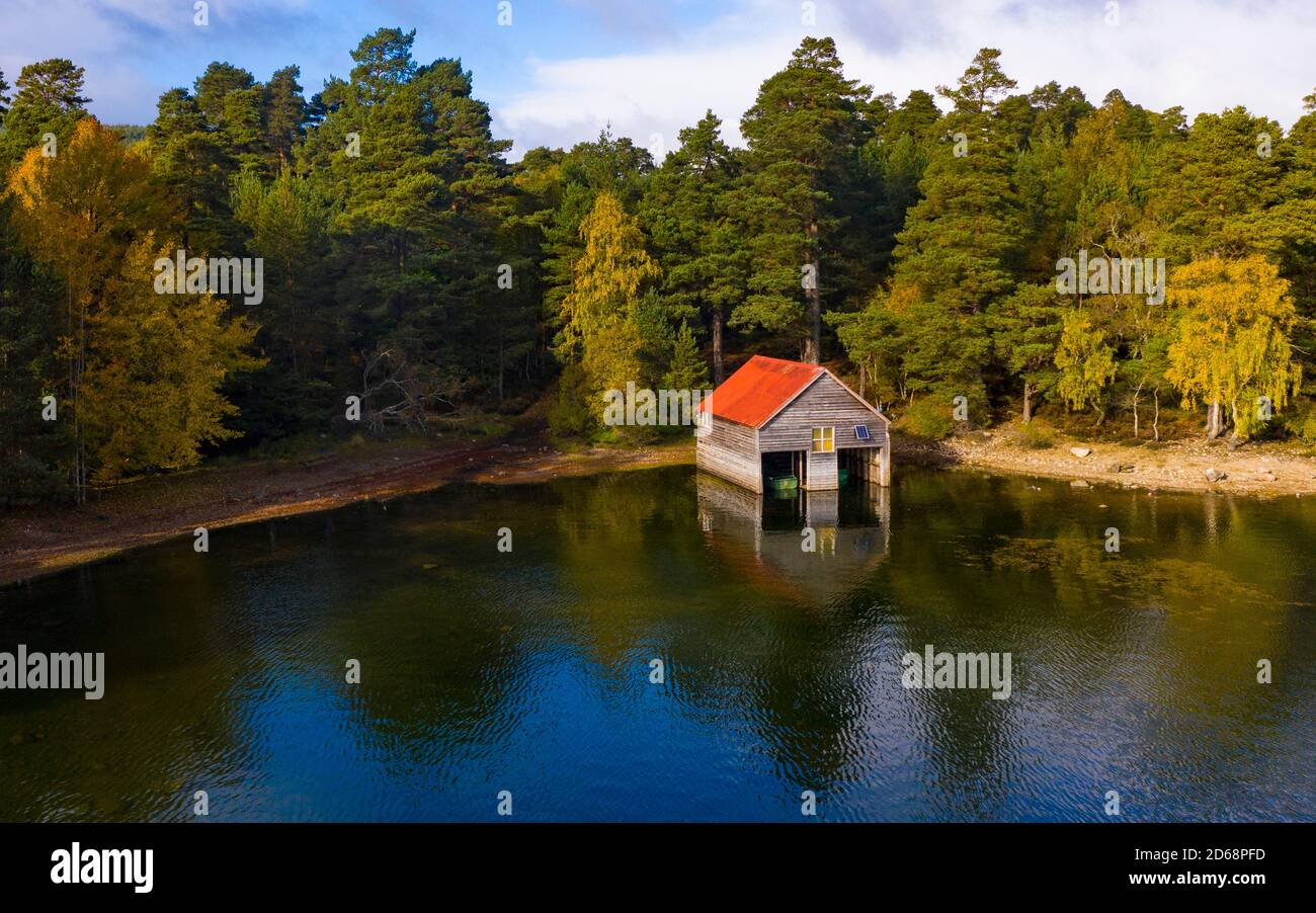 Aerial view of Loch Vaa and red boathouse in Cairngorms National Park ...