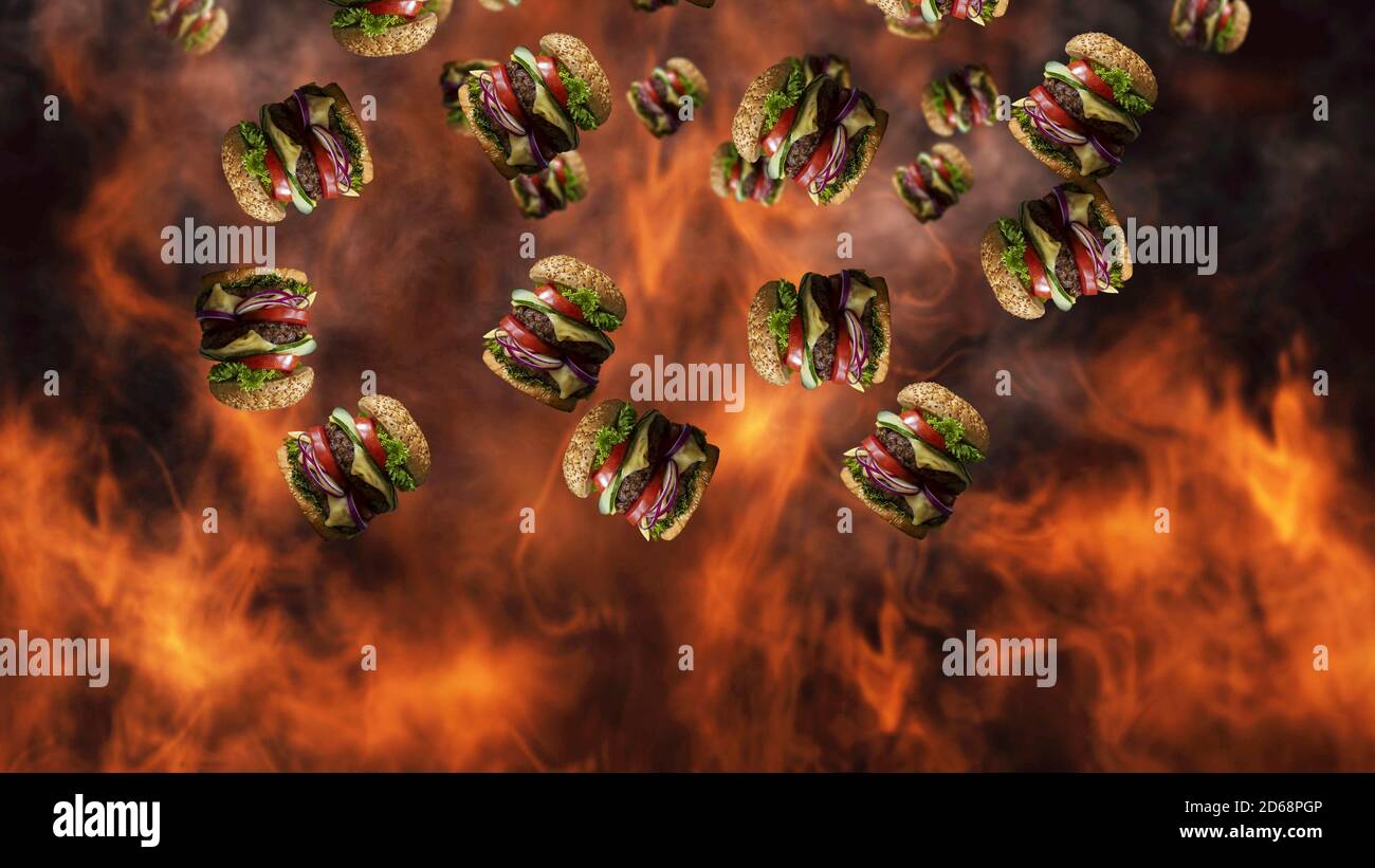Hamburgers falling with smoke and burning fire in background. Fast food ...
