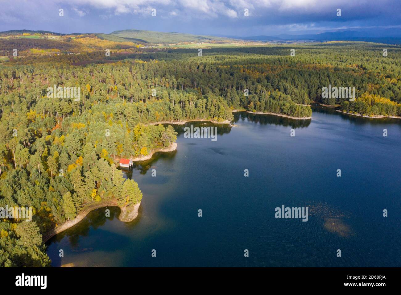 Aerial view of Loch Vaa and red boathouse in Cairngorms National Park ...