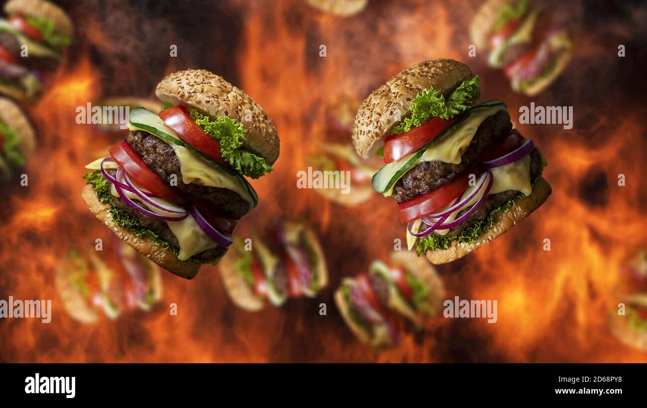 Hamburgers falling with smoke and burning fire in background. Fast food ...