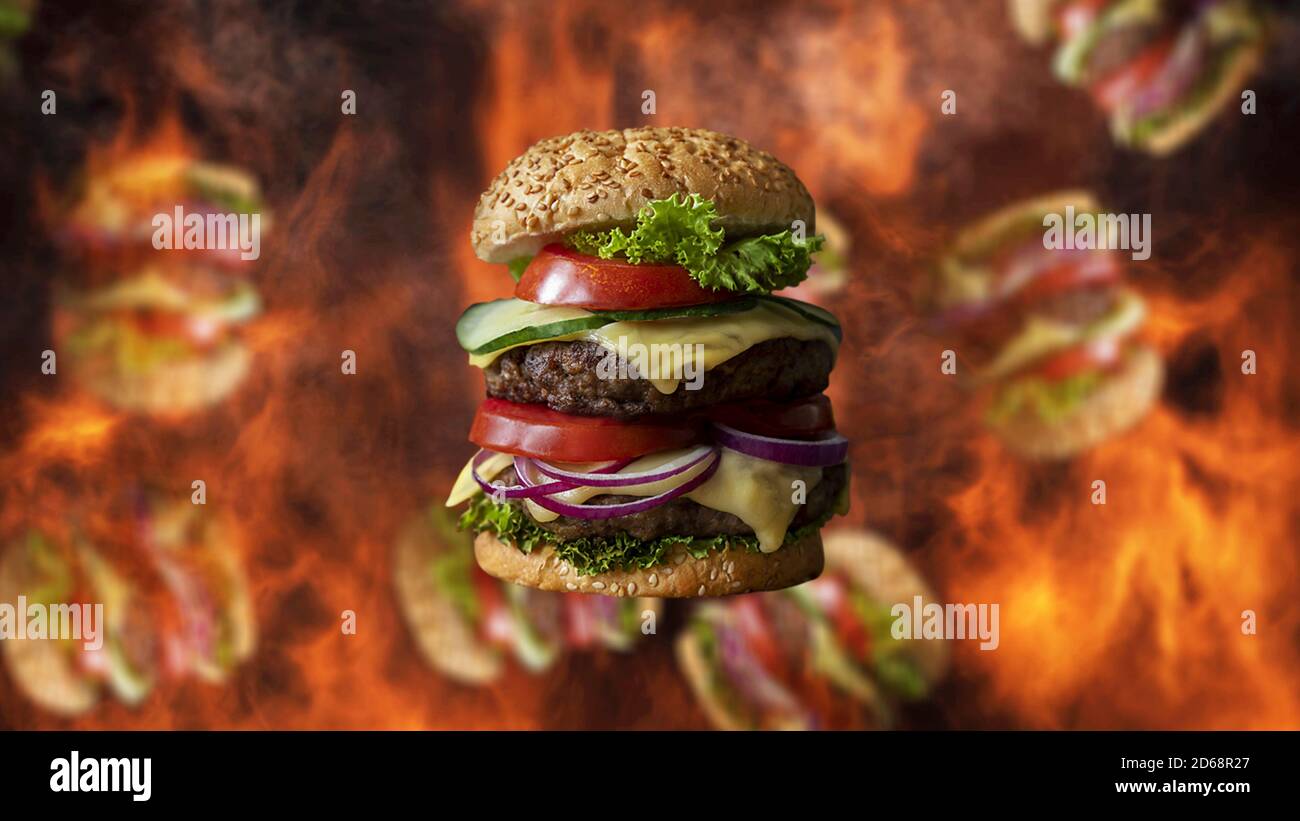 Hamburgers falling with smoke and burning fire in background. Fast food ...