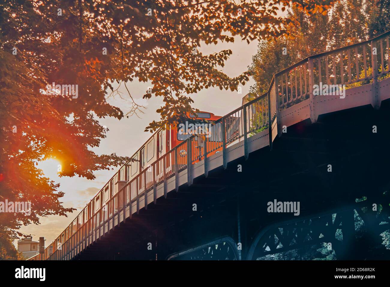 Yellow U-Bahn or subway train on the overpass. Sunset view of Berlin ...