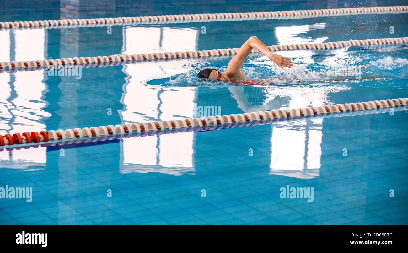 sports female swimmer swimming in the pool, swimming crawl. Side view ...