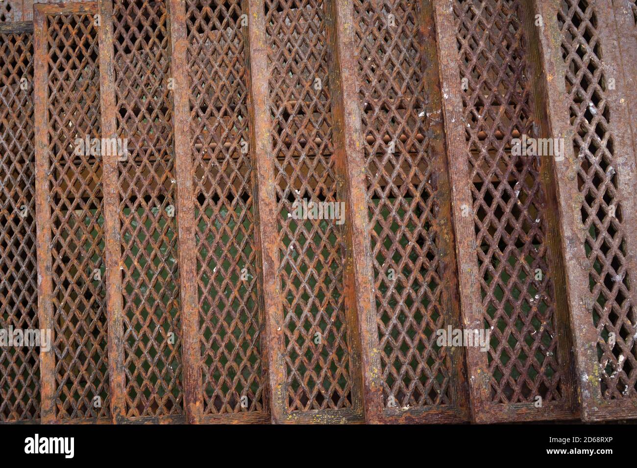 a set of Rusty metal stairs going down with steps, pattern of red ...