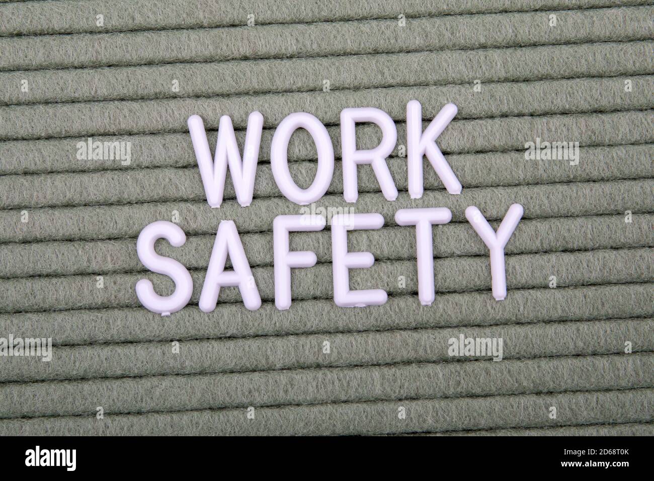 WORK SAFETY. White letters of the alphabet on a green background. Text ...